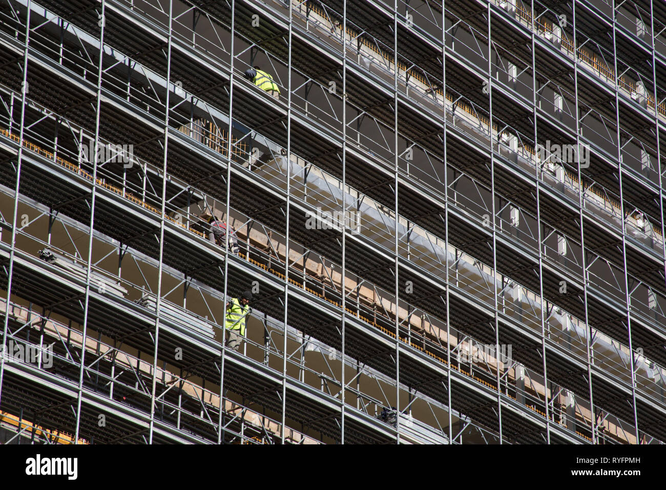 The abstract grid of scaffolding on a building under construction in ...