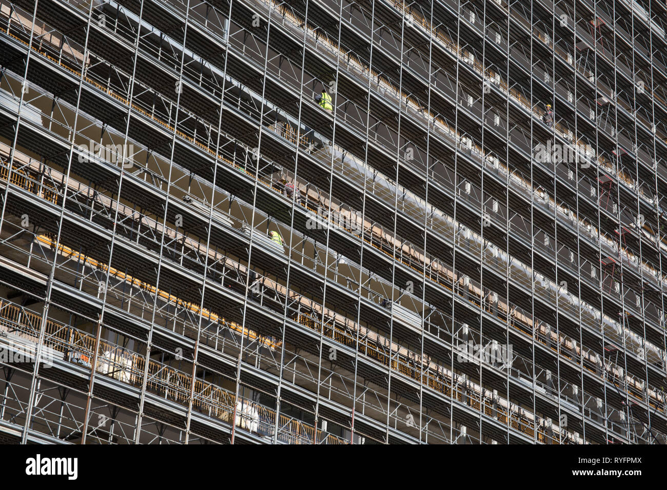 The abstract grid of scaffolding on a building under construction in ...