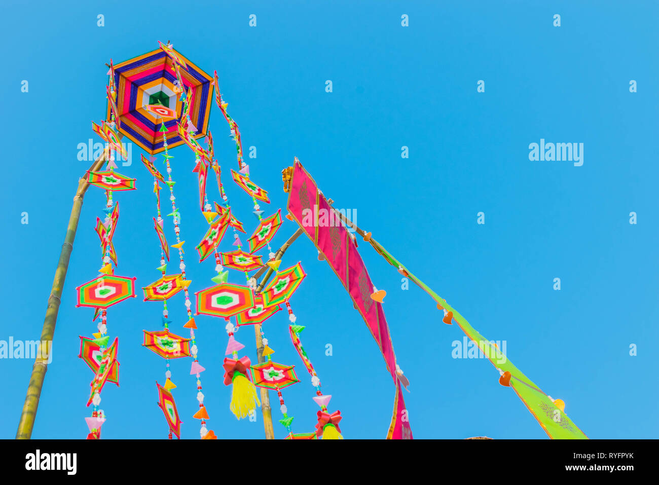 The wind blowing colorful flags with the blue sky background cloud.The ...