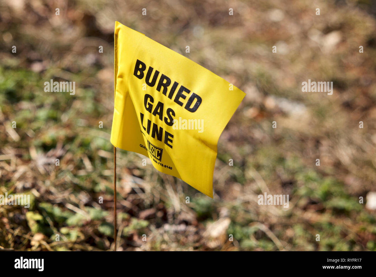 East Goshen, PA, USA - March 13, 2019: A yellow flag warns of buried ...