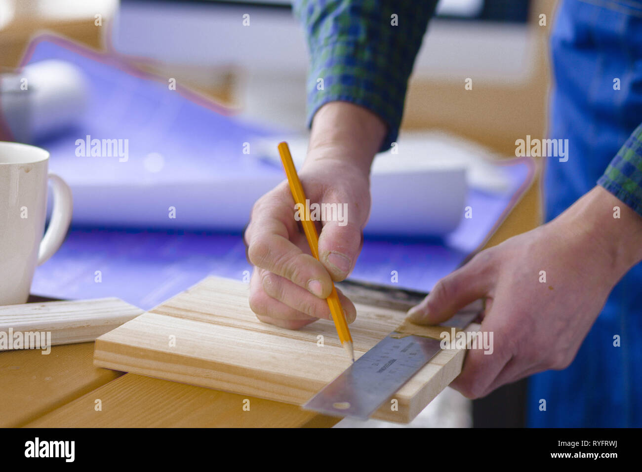 Engineer carpenter working on laptop and sketching project Stock Photo ...