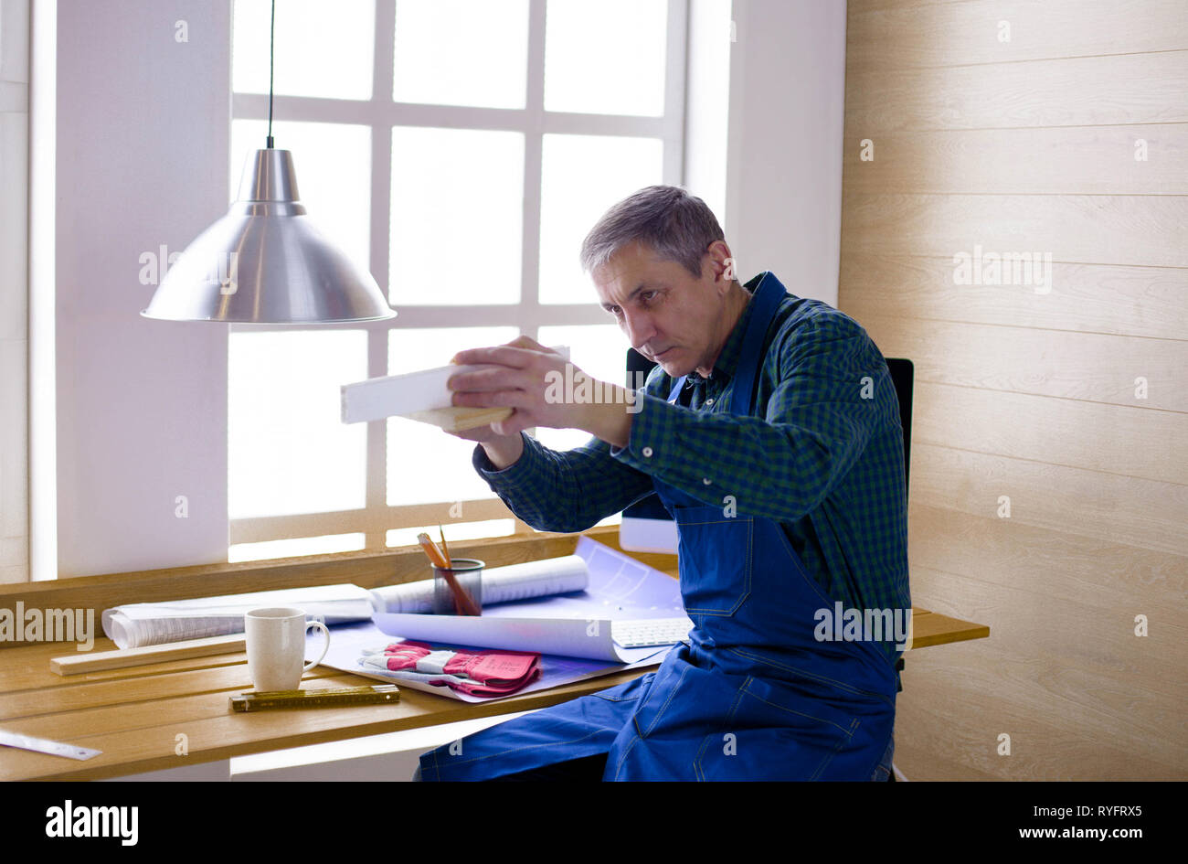 Engineer carpenter working on laptop and sketching project Stock Photo ...