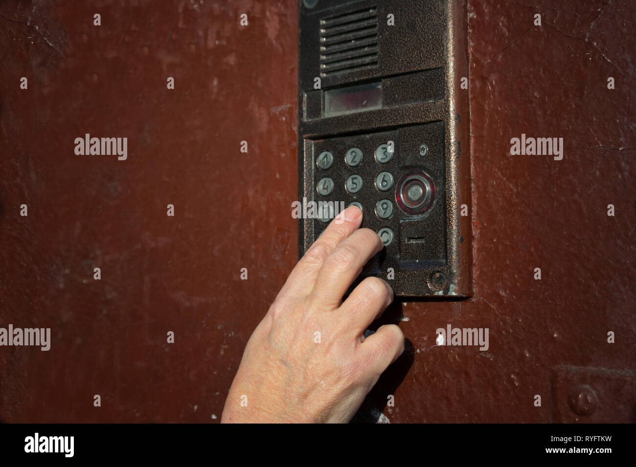 A hand entering code on front door electronic lock Stock Photo - Alamy