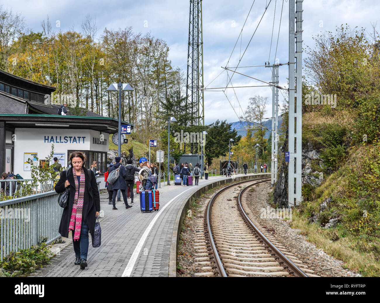 Hallstatt, Austria - Oct 25, 2018. Passengers waiting at train station ...