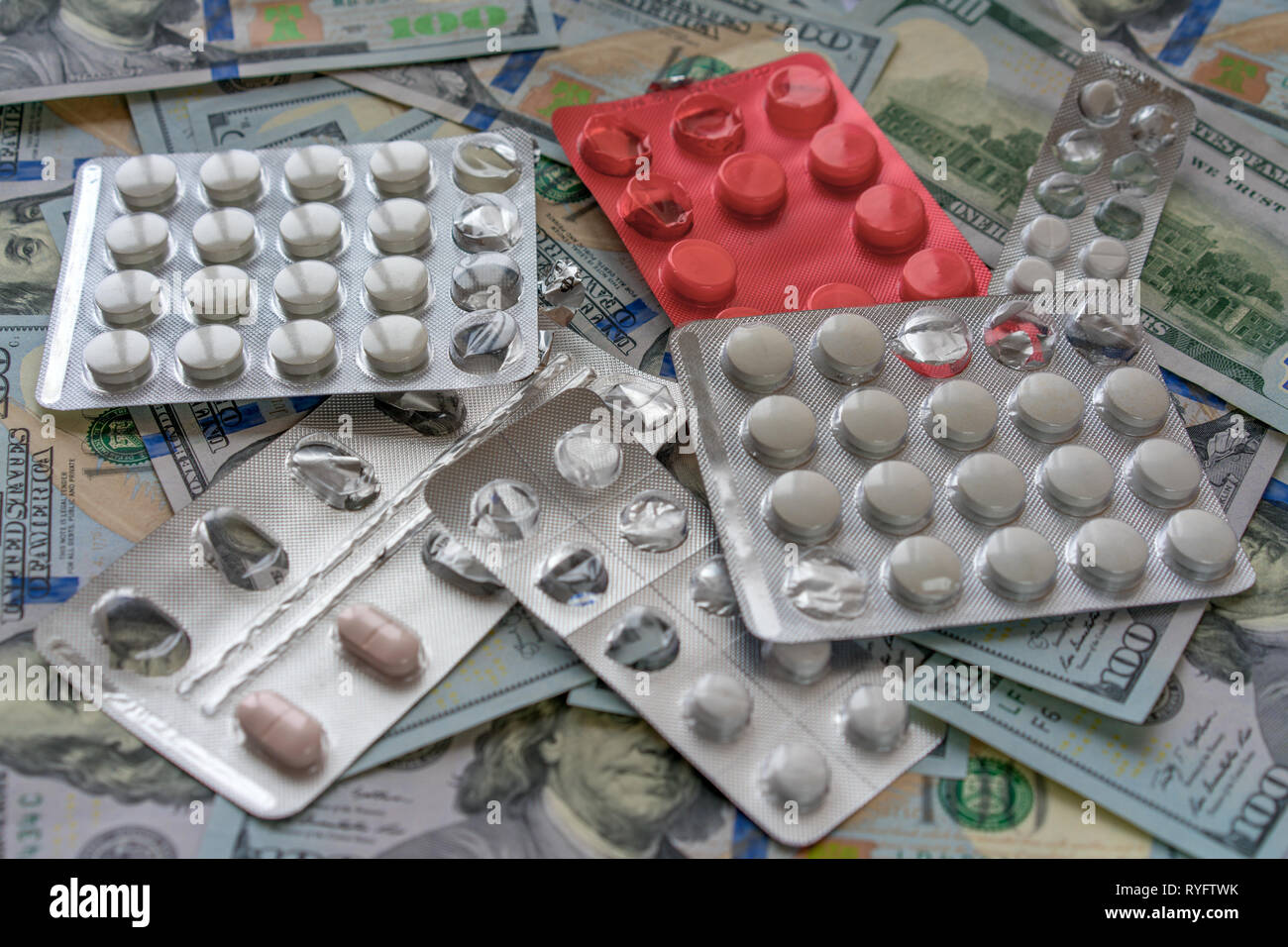 Pills on 100 dollar money. Medicine expenses. High costs of expensive ...