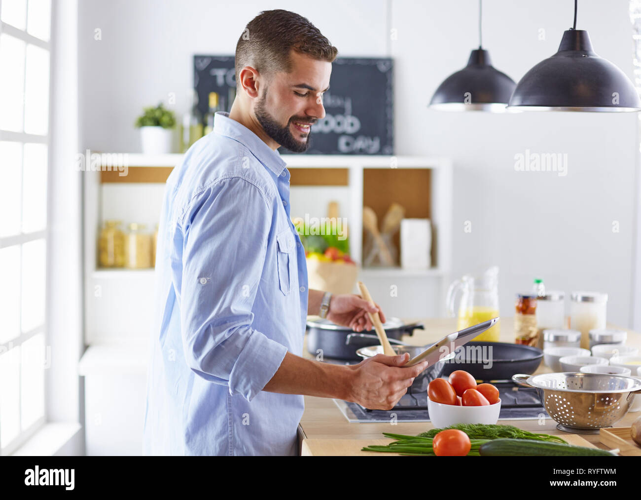 Smiling and confident chef standing in large kitchen Stock Photo - Alamy