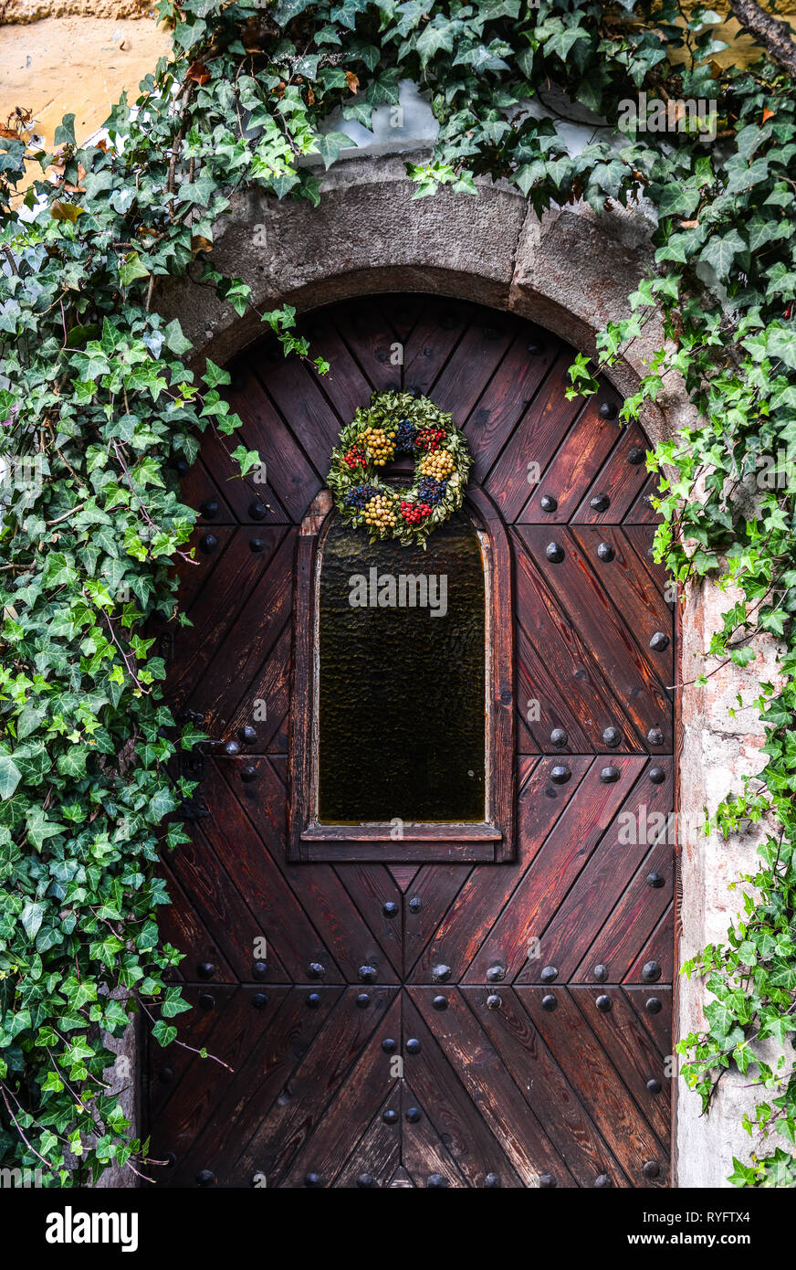 Old building with brick walls, wooden doors and plants Stock Photo - Alamy