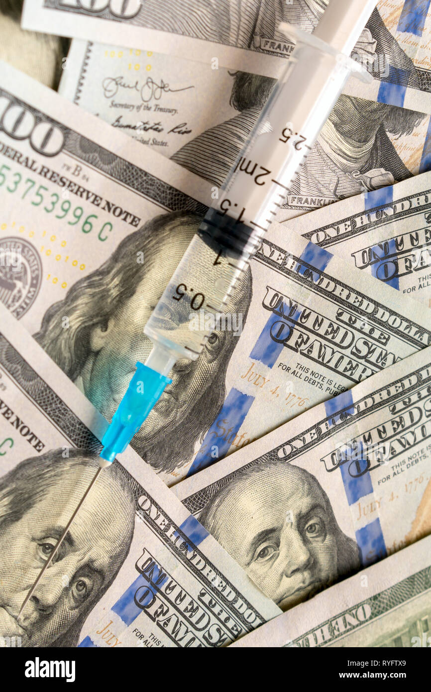 close up of syringe with injection on dollar banknotes Stock Photo - Alamy