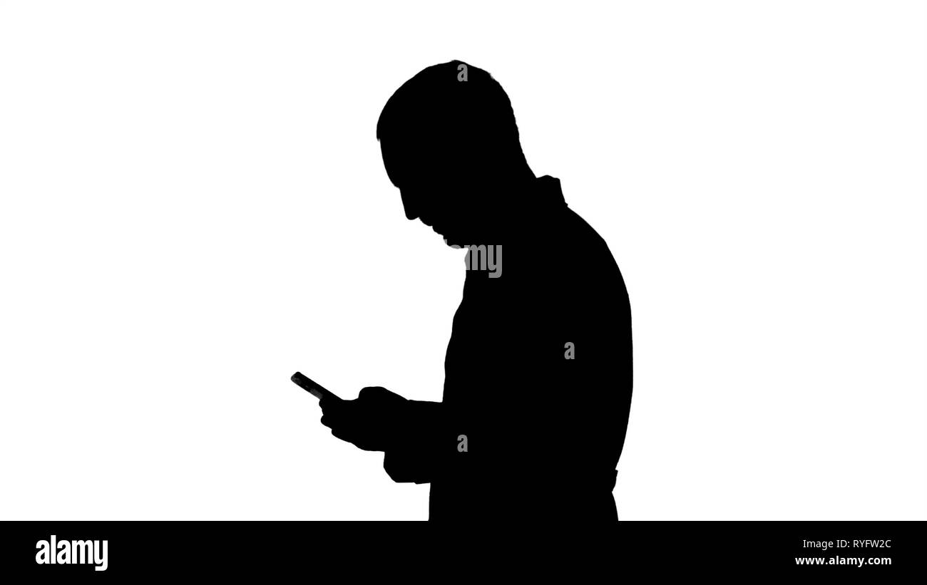 Silhouette Walking doctor or nurse texting on a cell phone Stock Photo ...