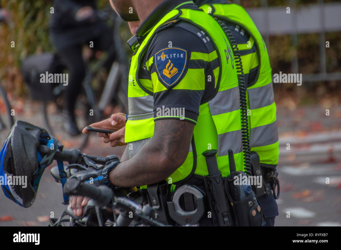 Close Of Police Men With Bicycles At Amsterdam The Netherlands 2018 ...