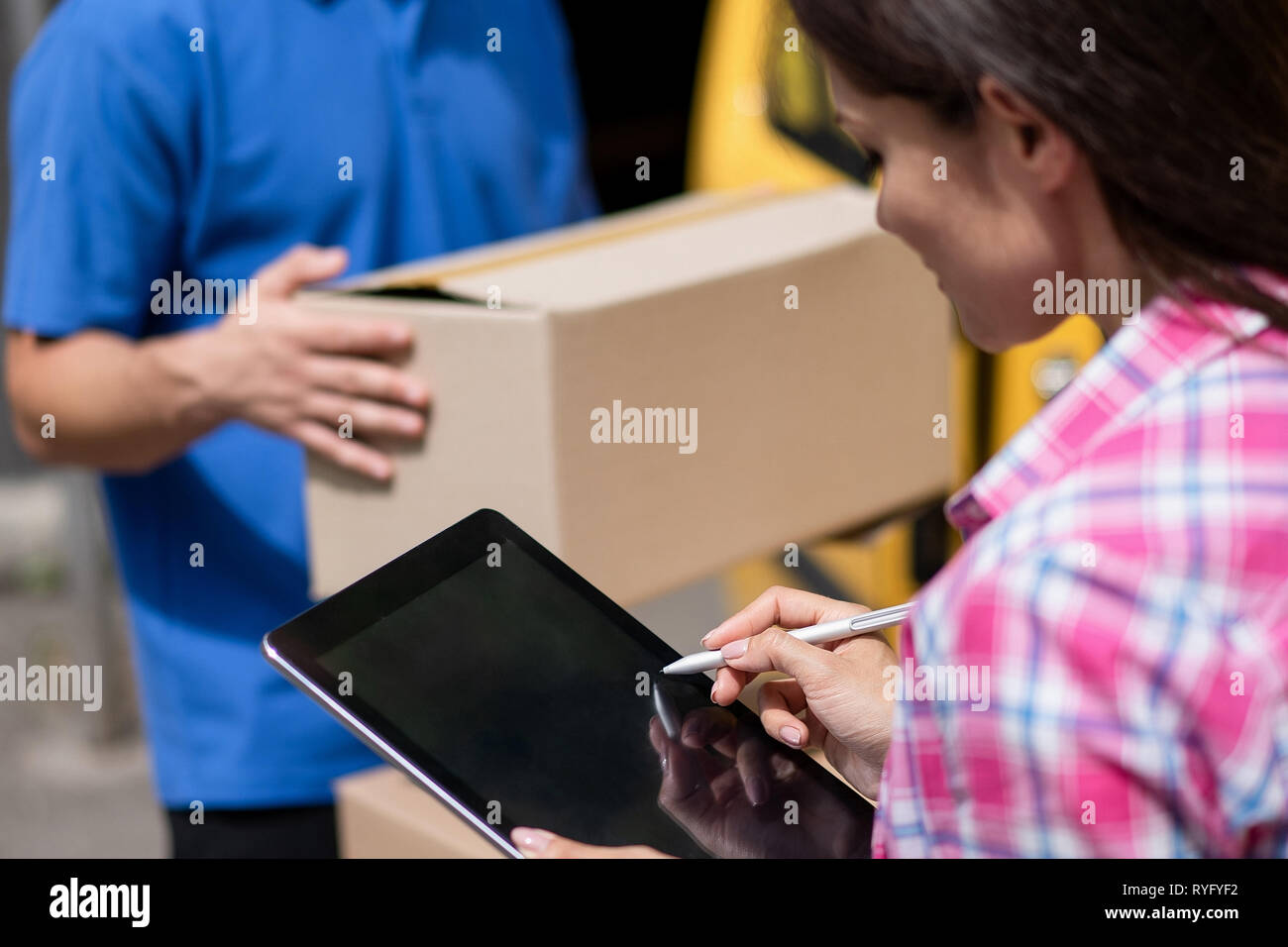 Female client signs for delivery in tablet app Stock Photo - Alamy