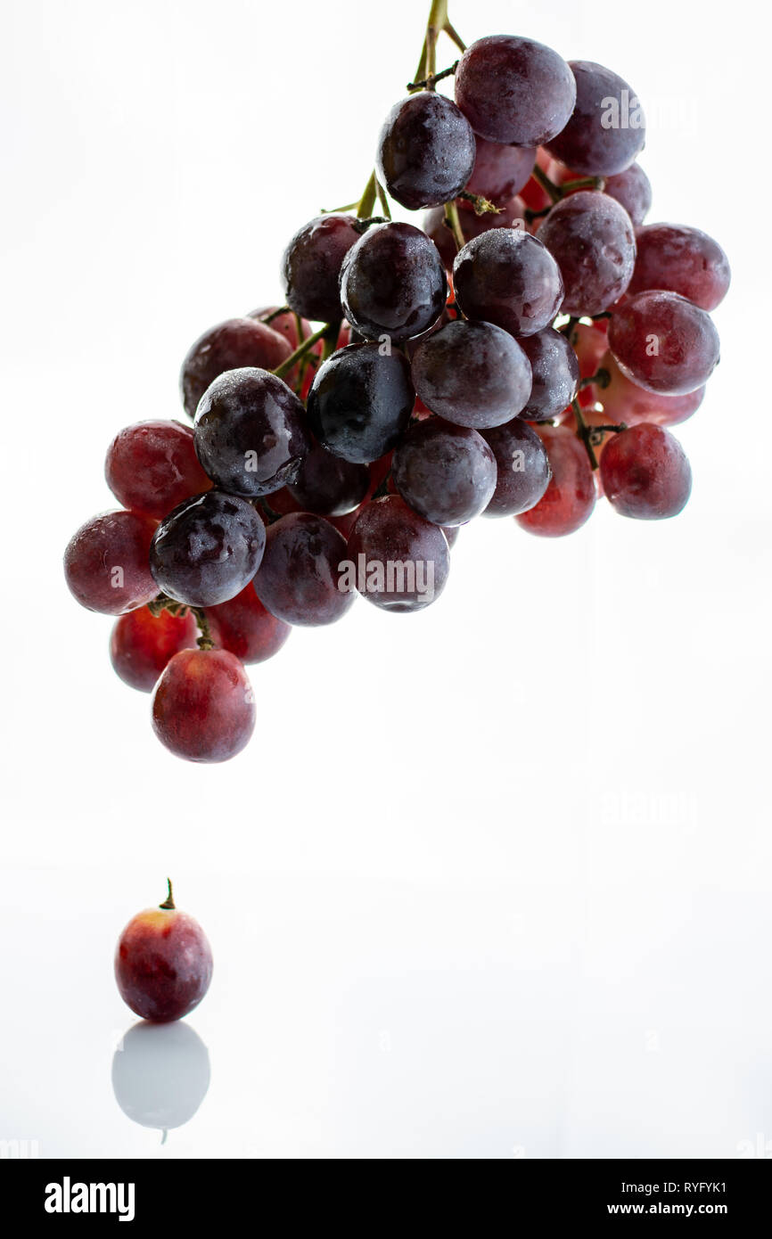 Wet red grape cluster isolated on white background Stock Photo - Alamy