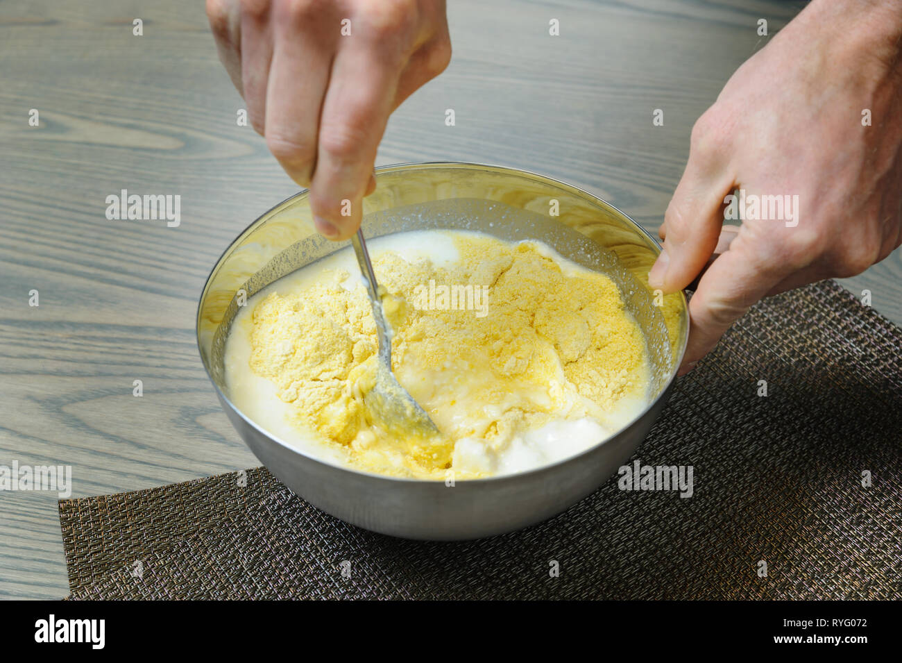 Preparation baking the pie. Hands cook stir dough in a metal bowl Stock ...