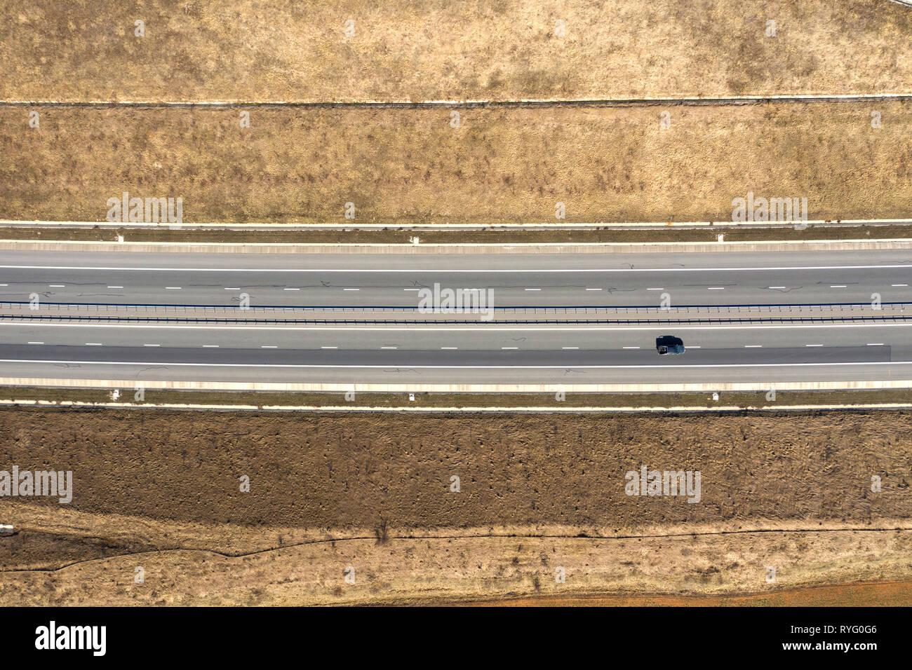 Aerial top view of cars and trucks passing on a highway, drone shot ...