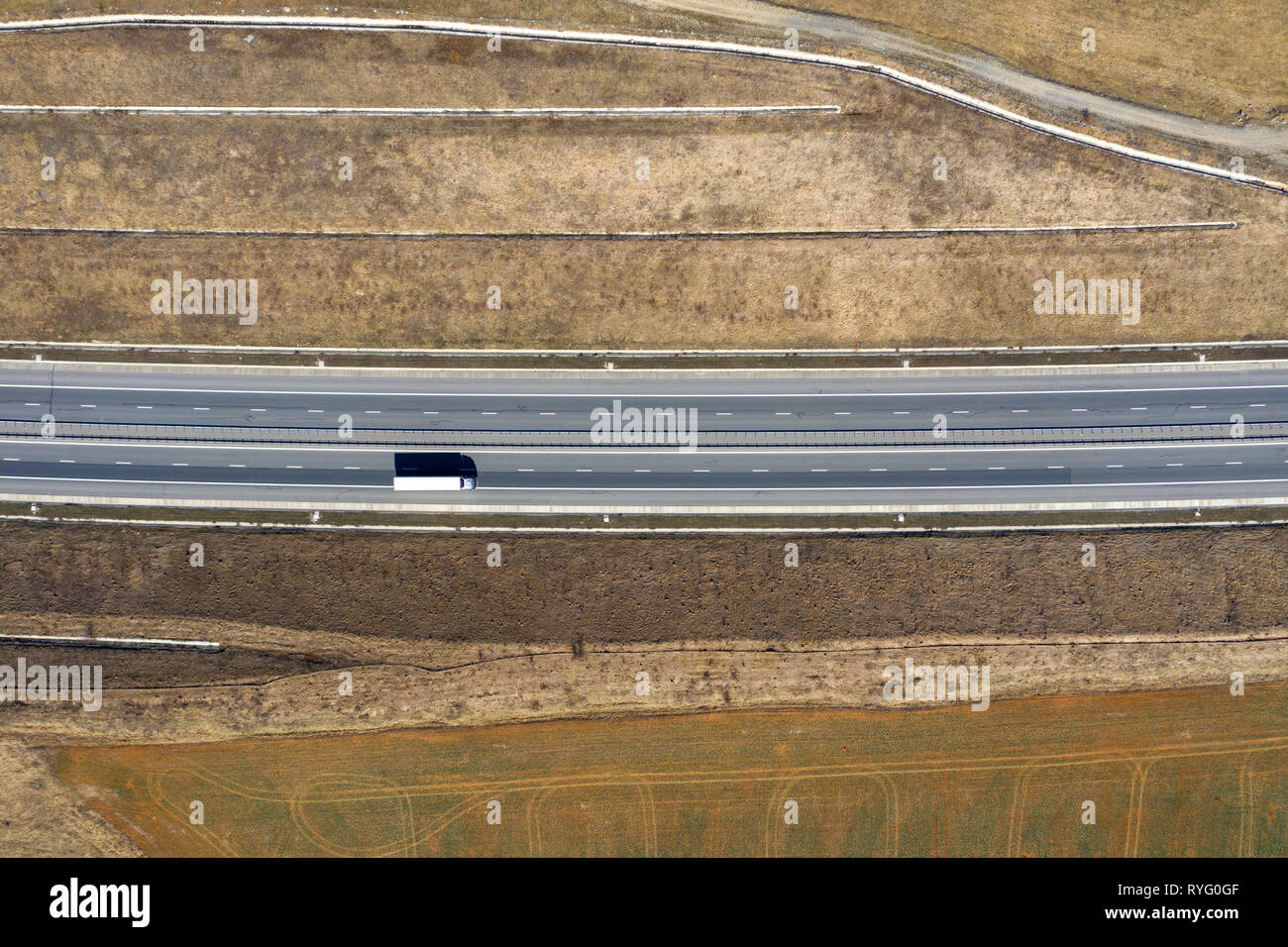 Aerial top view of cars and trucks passing on a highway, drone shot ...
