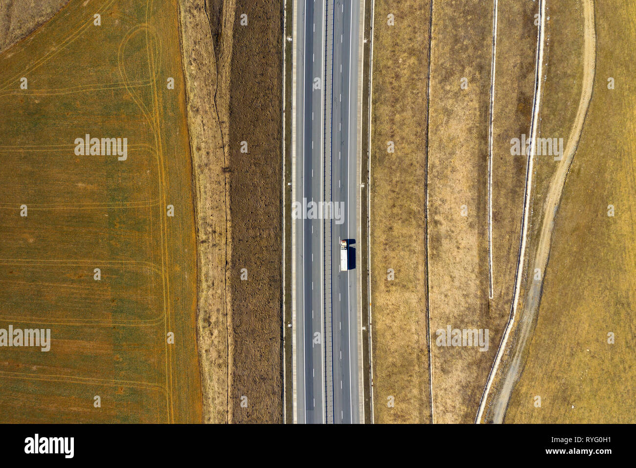 Aerial top view of cars and trucks passing on a highway, drone shot ...