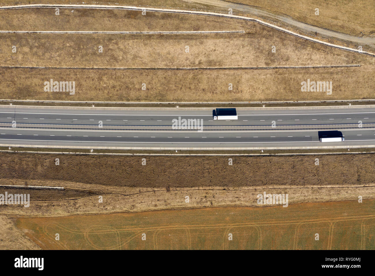 Aerial top view of cars and trucks passing on a highway, drone shot ...