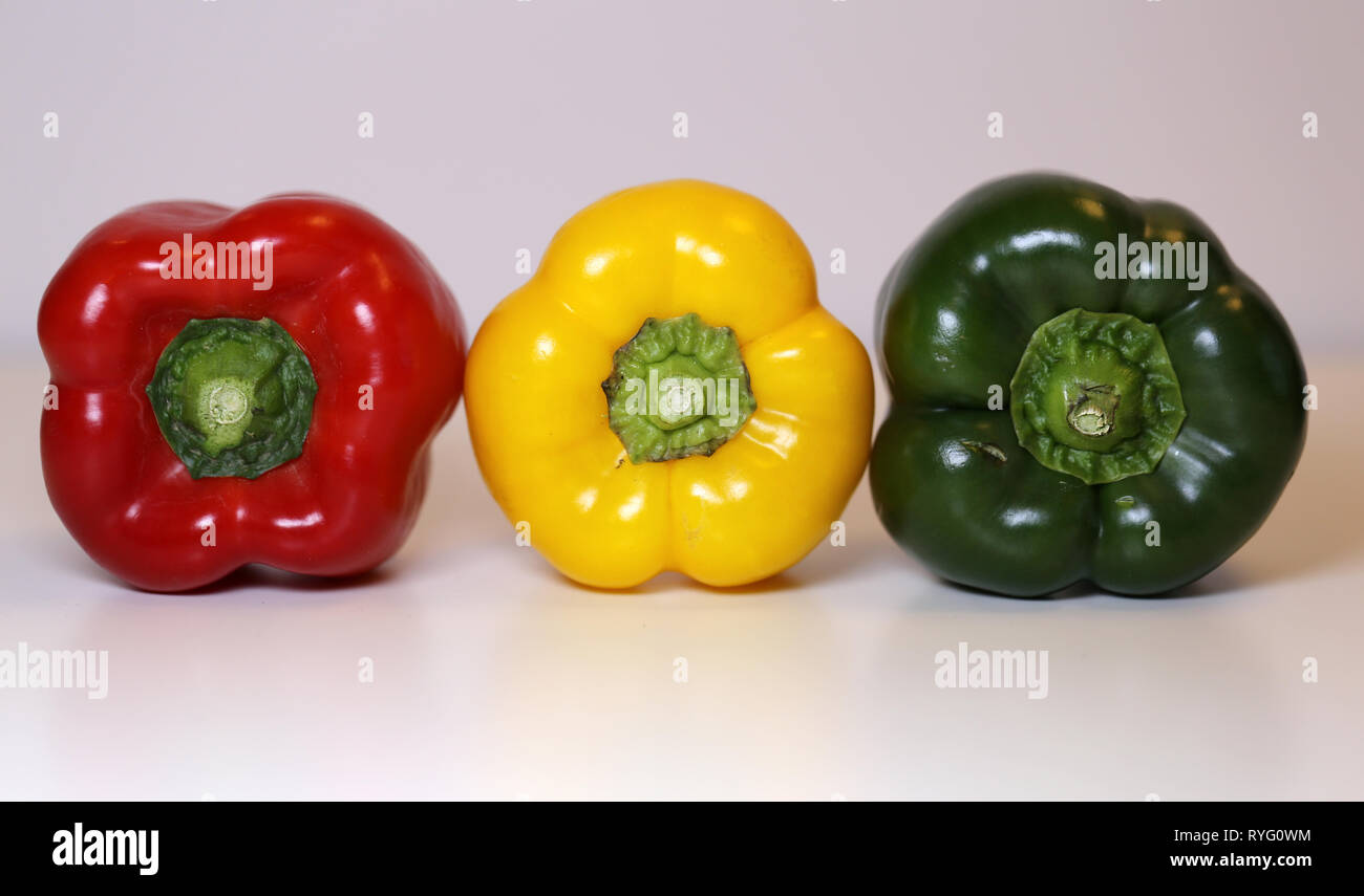 Colorful bell peppers on a white table. Beautiful still life image of ...