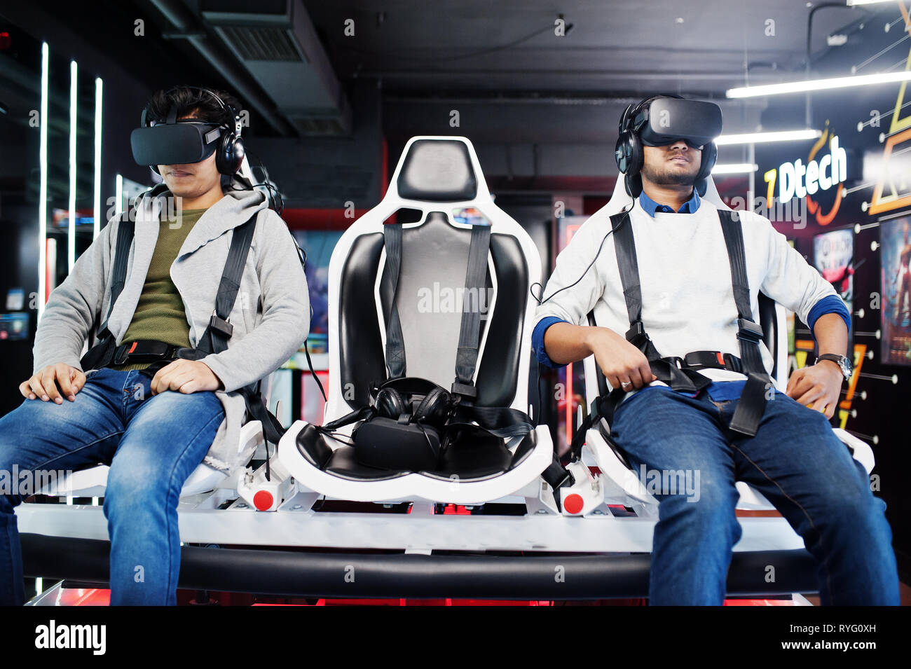 Two young indian people having fun with a new technology of a vr ...