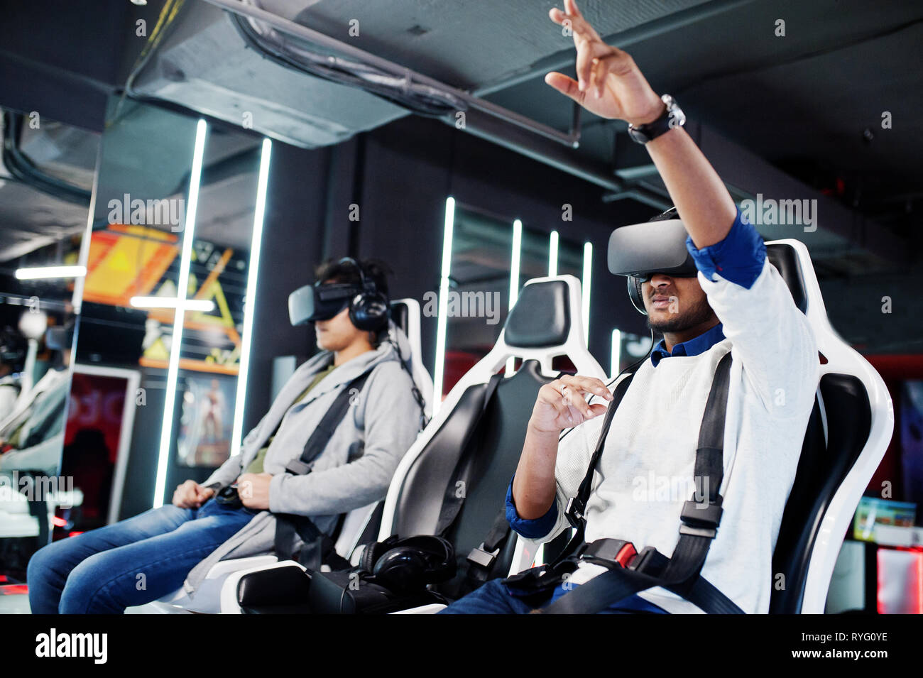 Two young indian people having fun with a new technology of a vr ...