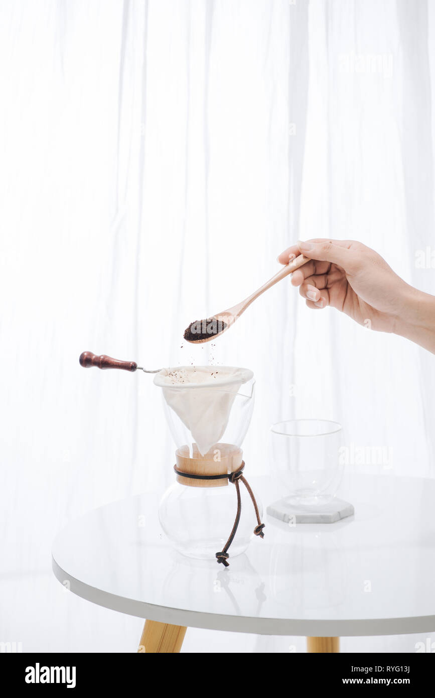 fill grind coffee in filter with wooden spoon Stock Photo - Alamy