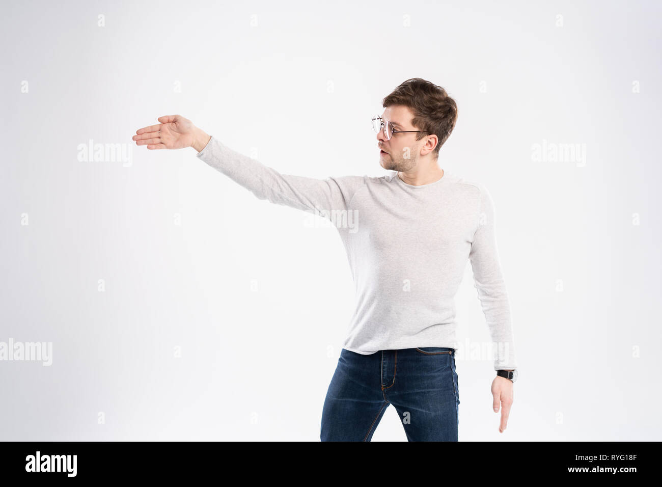 Happy smiling young man presenting and showing your text or product ...