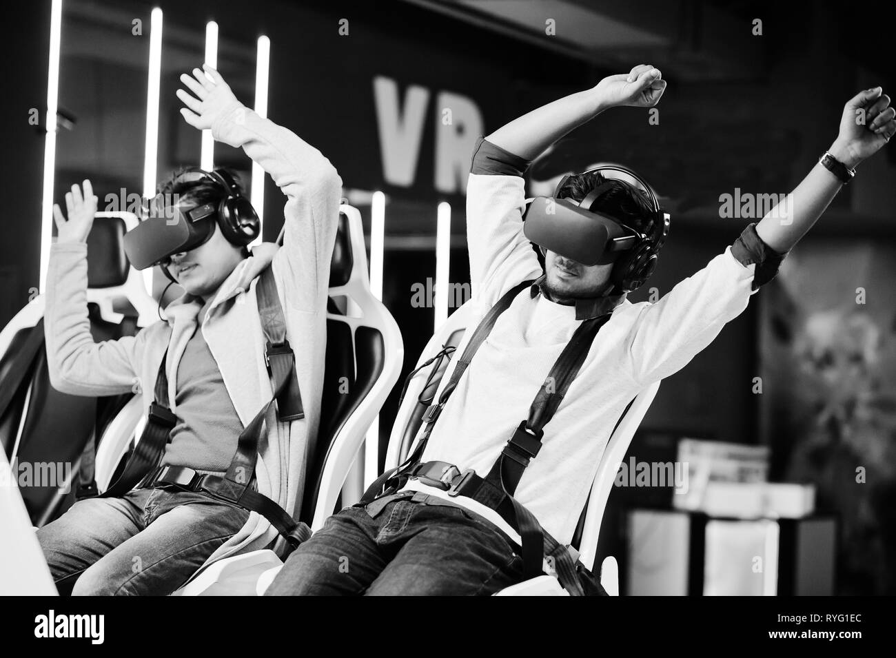Two young indian people having fun with a new technology of a vr ...