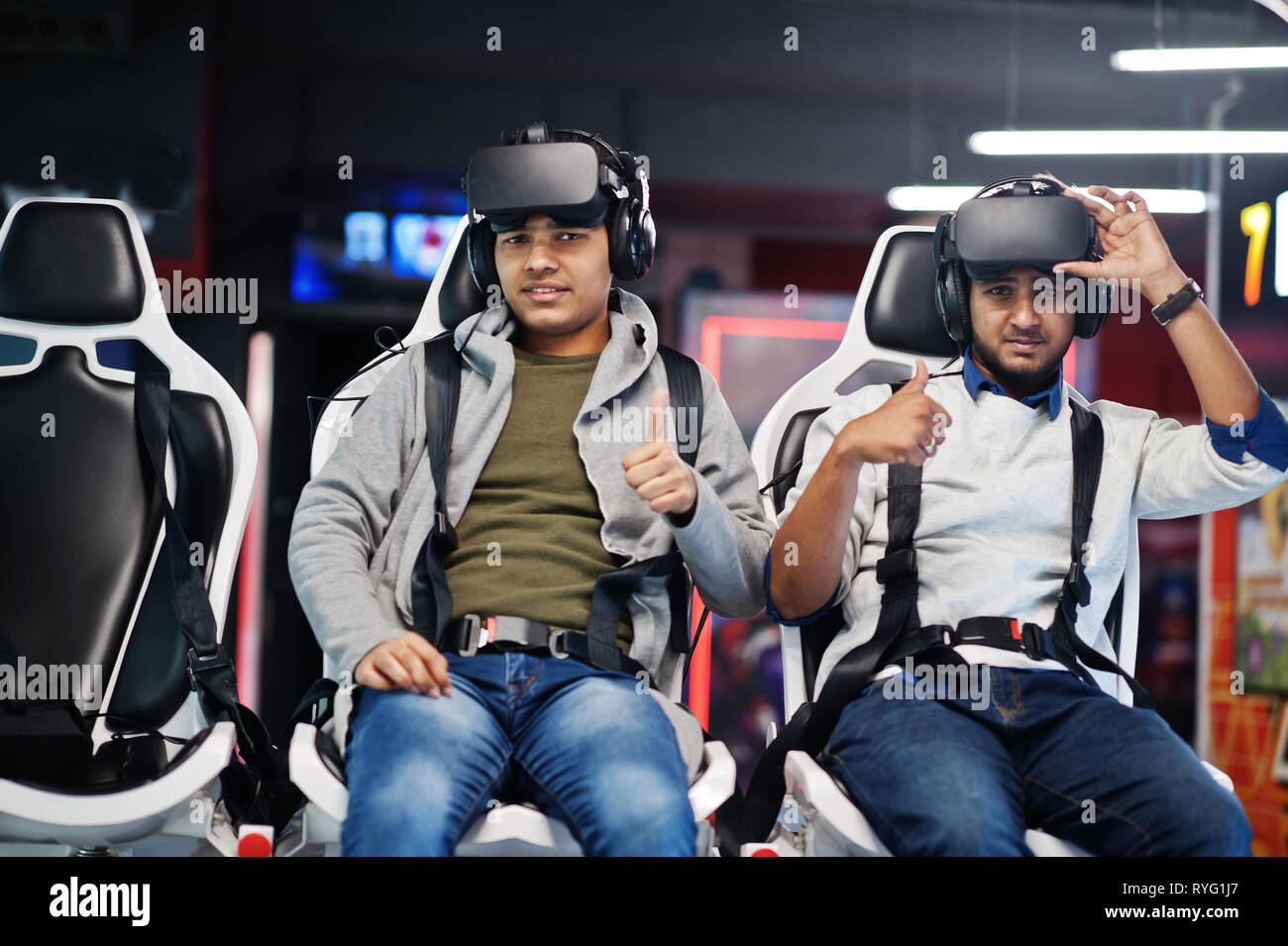 Two young indian people having fun with a new technology of a vr ...