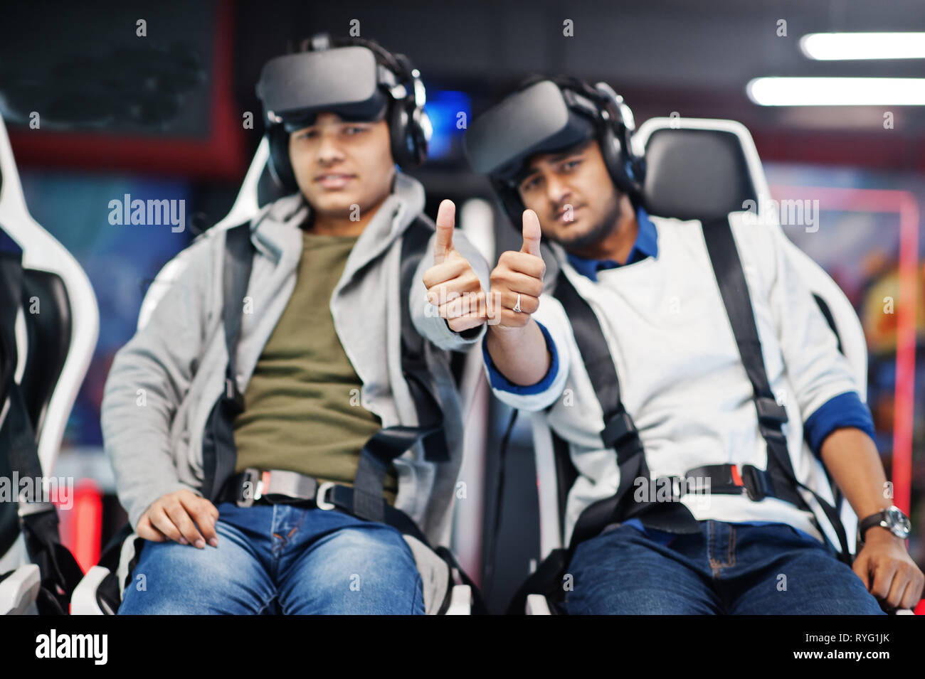 Two young indian people having fun with a new technology of a vr ...