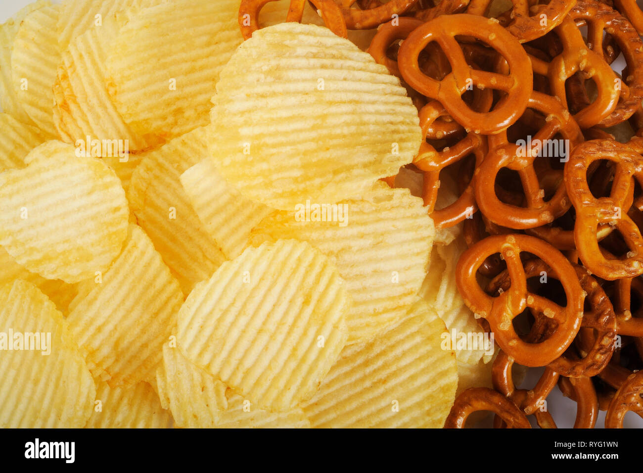 Salty snacks background Stock Photo - Alamy