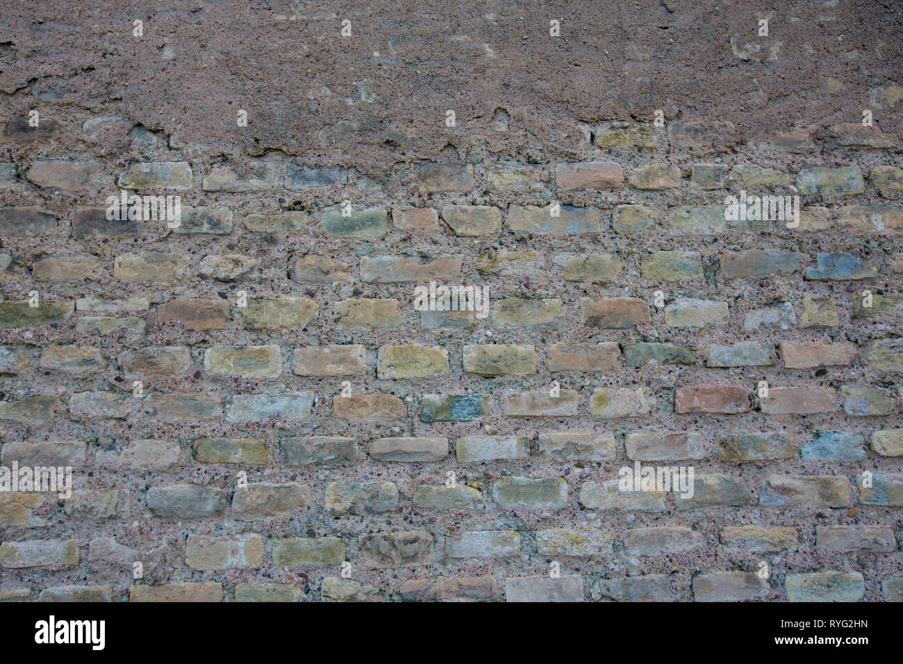 Abstract old masonry wall texture, different colored and shaped bricks ...