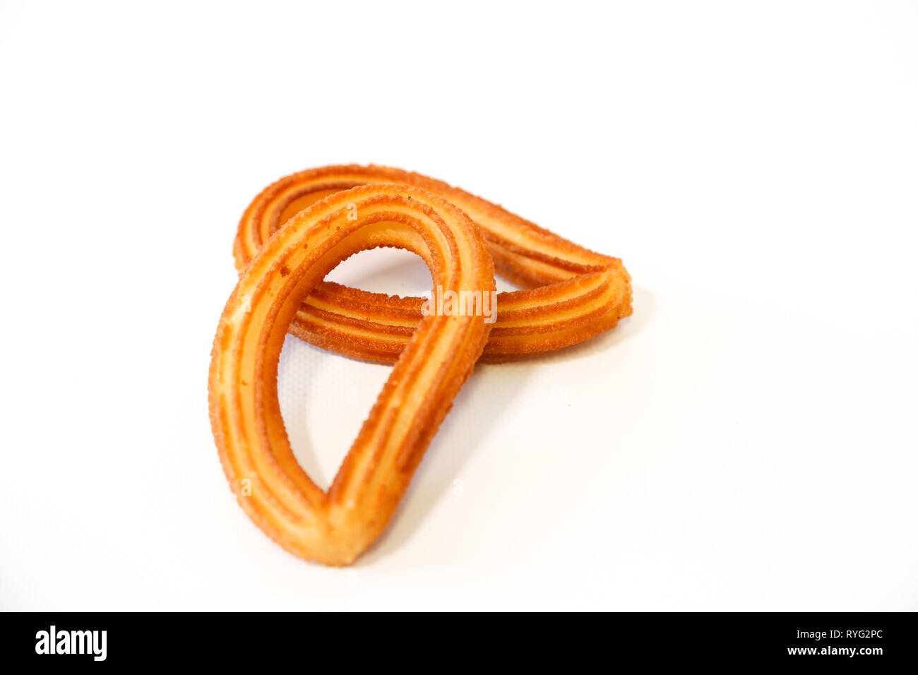two spanish fritters on white background Stock Photo - Alamy