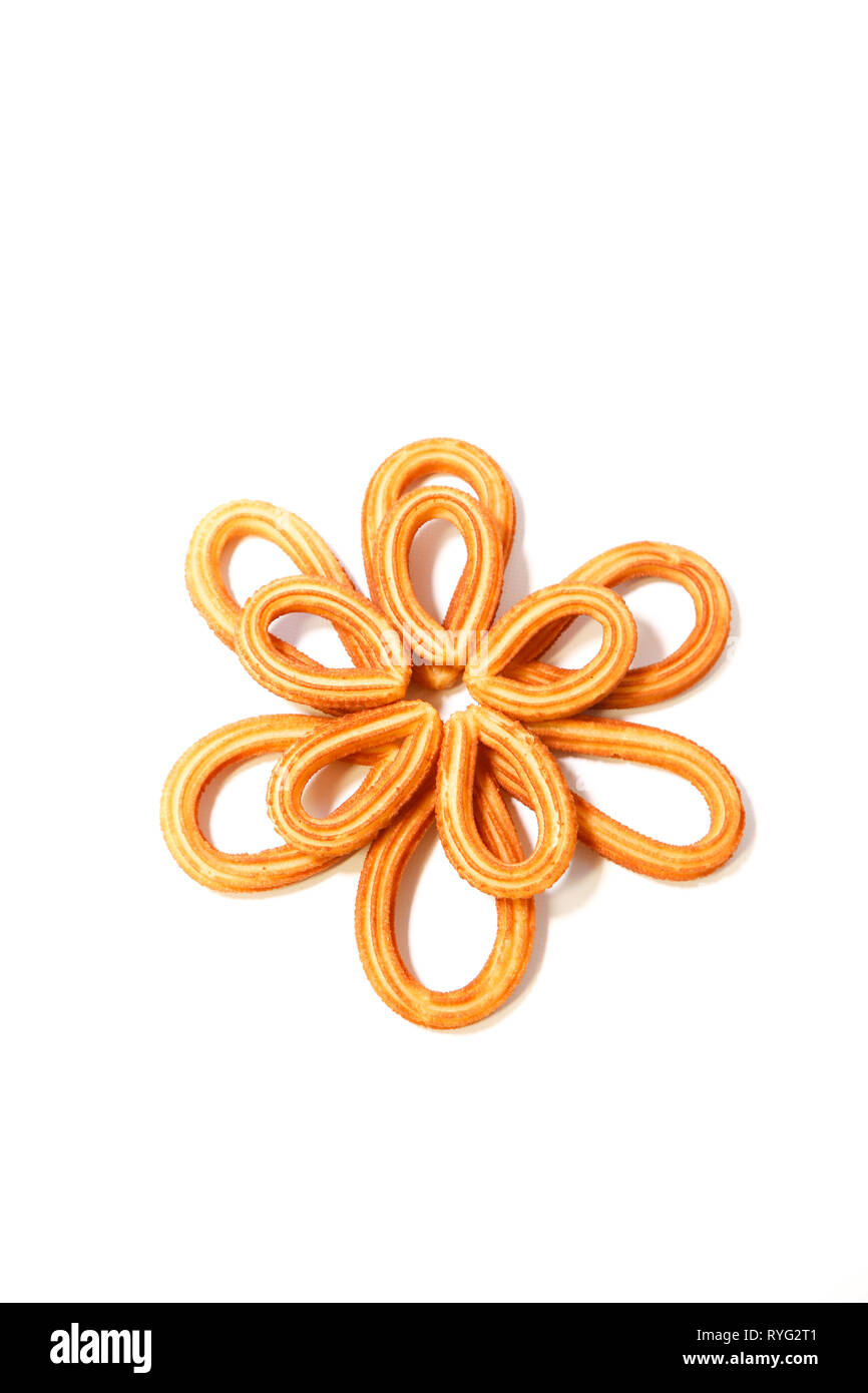 spanish fritters in flower shape on white background Stock Photo - Alamy