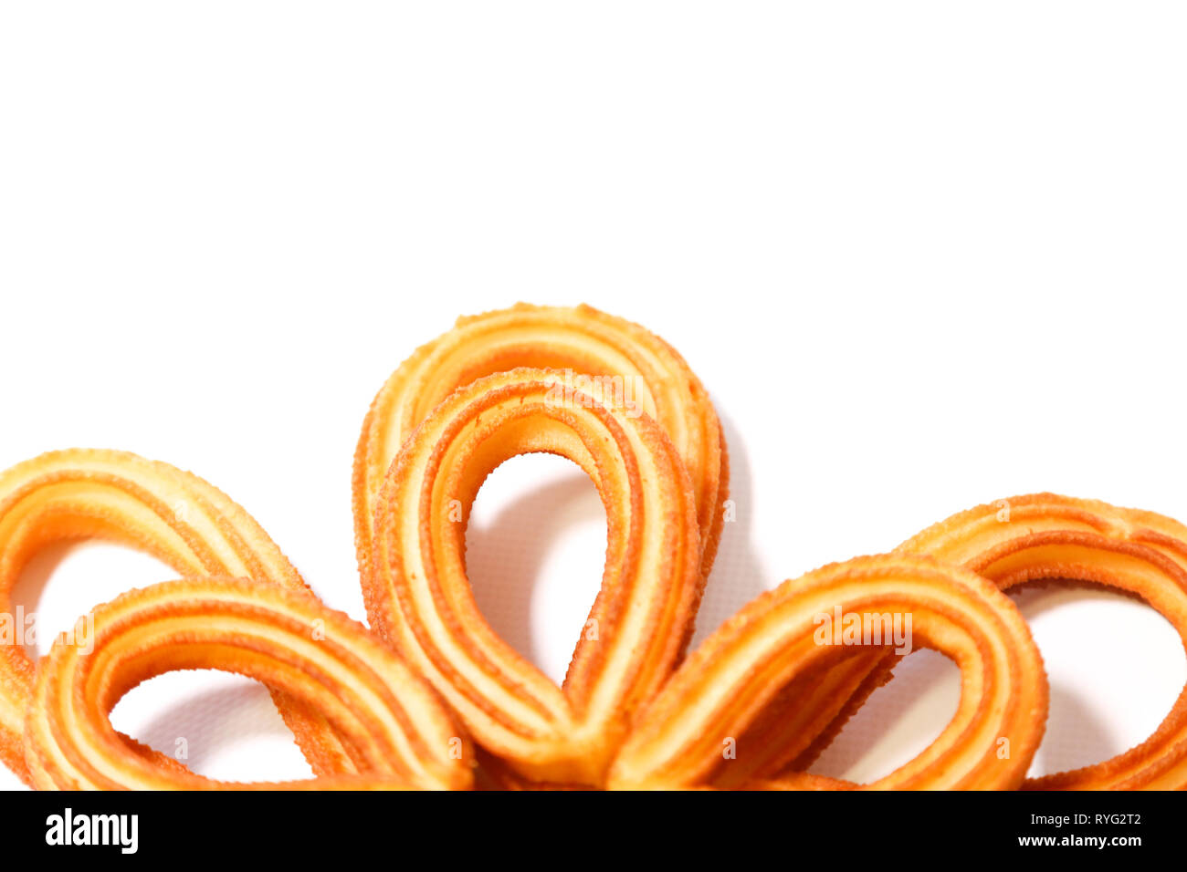 spanish fritters in flower shape on white background Stock Photo - Alamy