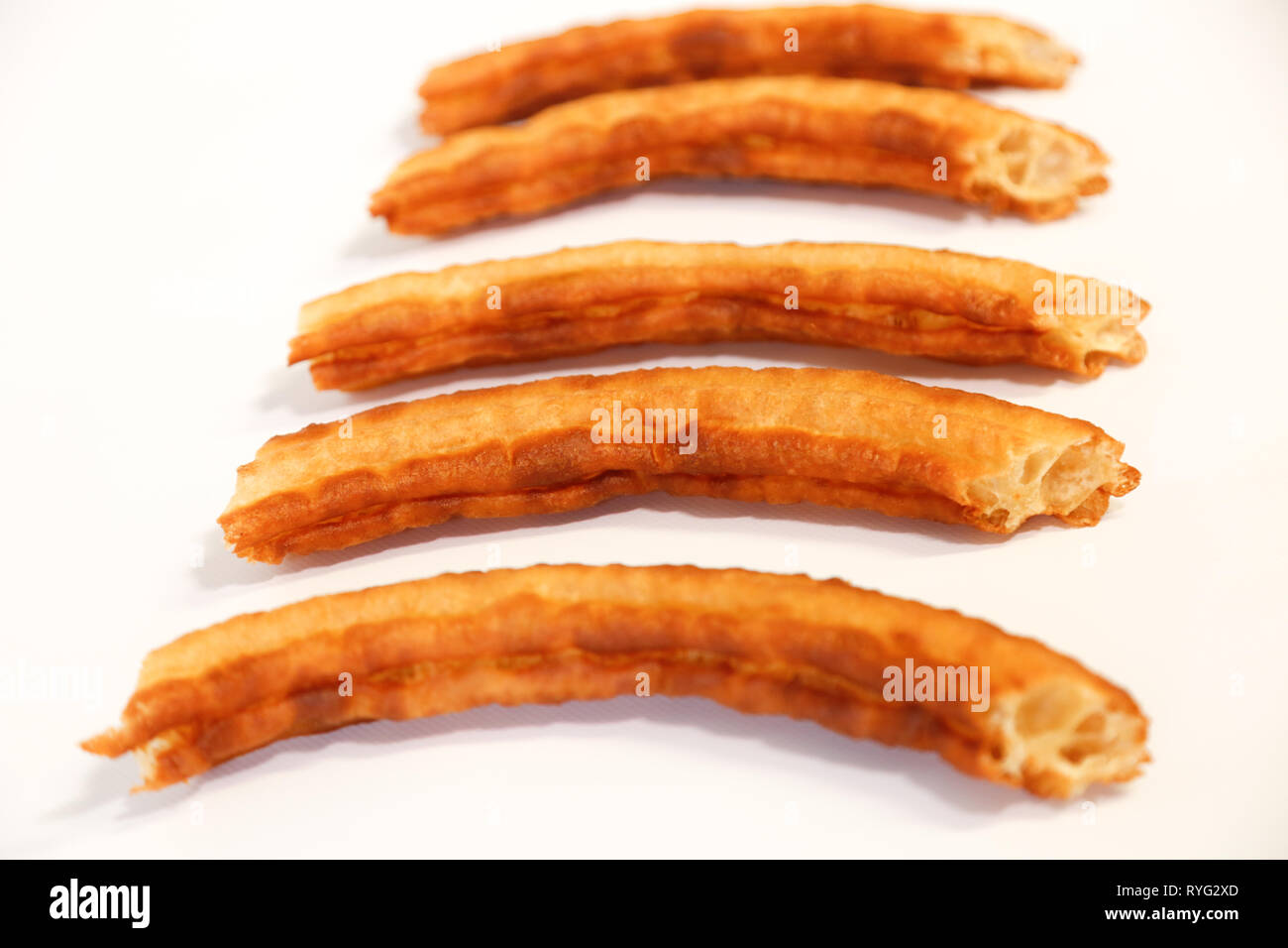 spanish fritters on white background Stock Photo - Alamy