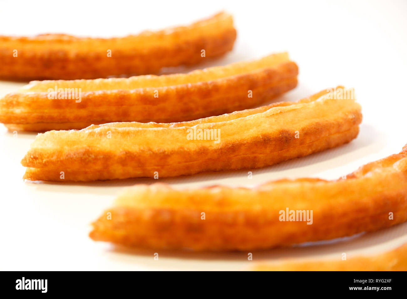 spanish fritters on white background Stock Photo - Alamy