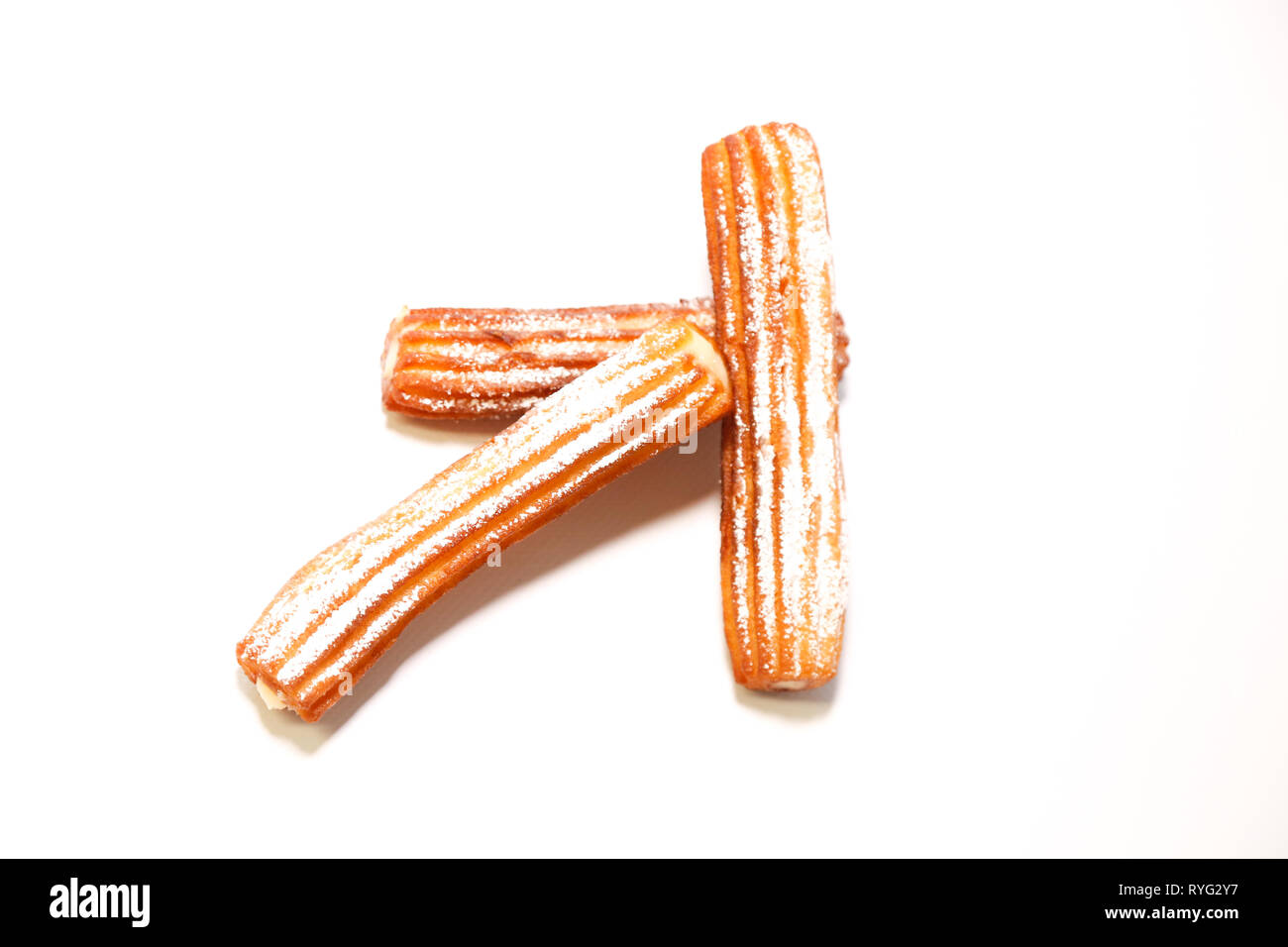 spanish fritters filled with cream on white background Stock Photo - Alamy