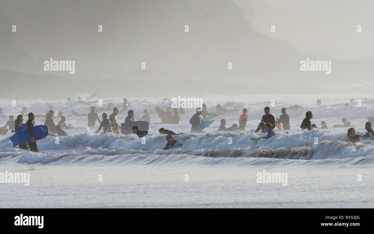 Surfers and boogie boarders in the waves, Hayle Bay, Polzeath, Cornwall ...