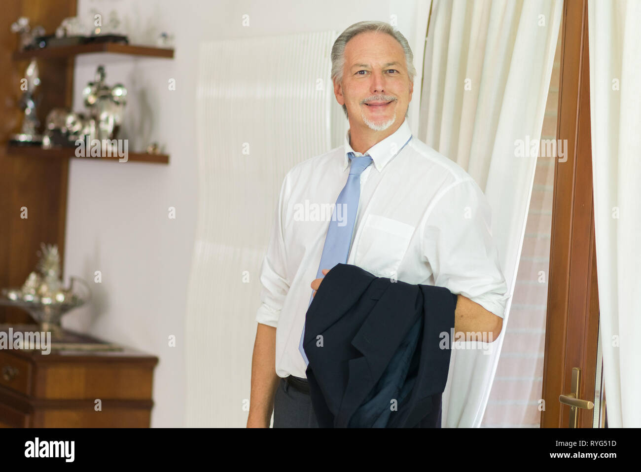 Businessman back home after work Stock Photo - Alamy