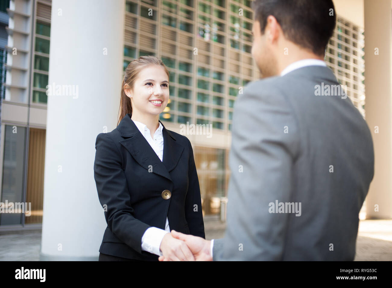 Smiling female manager shaking hands Stock Photo - Alamy