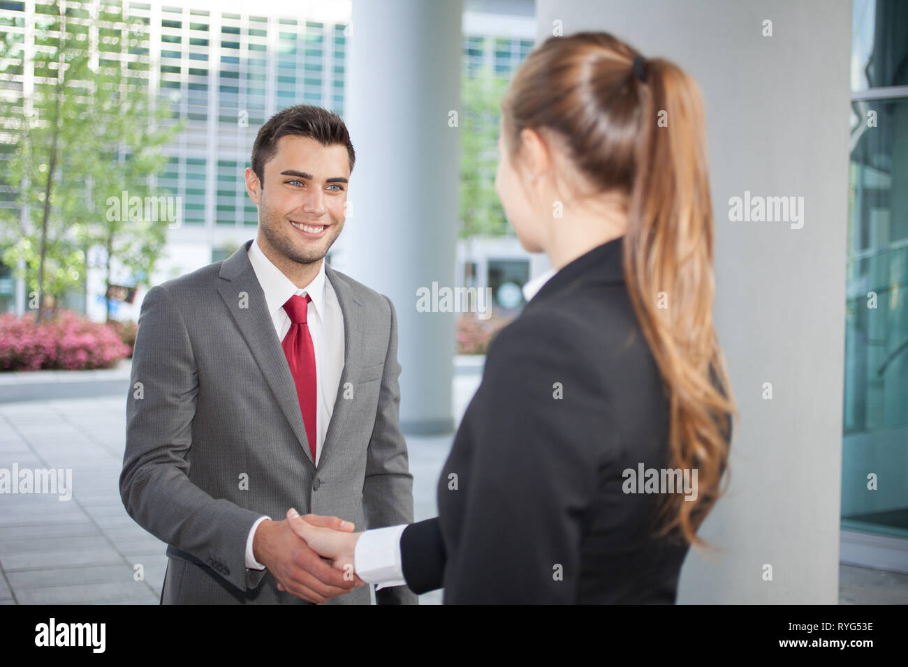 Smiling female manager shaking hands Stock Photo - Alamy