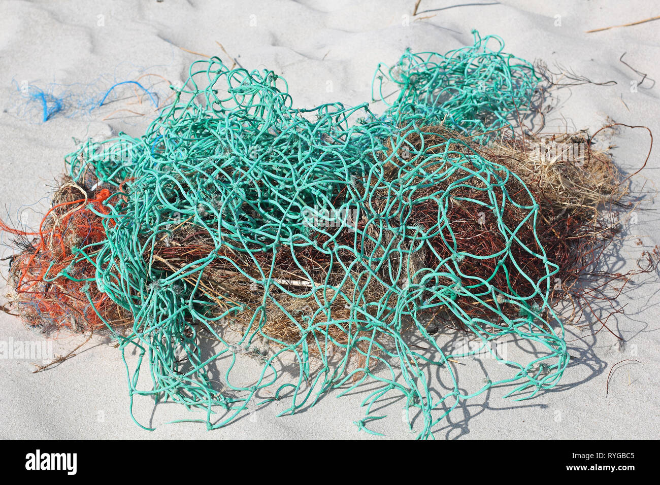Plastic garbage and residues of nets on the beach Stock Photo - Alamy
