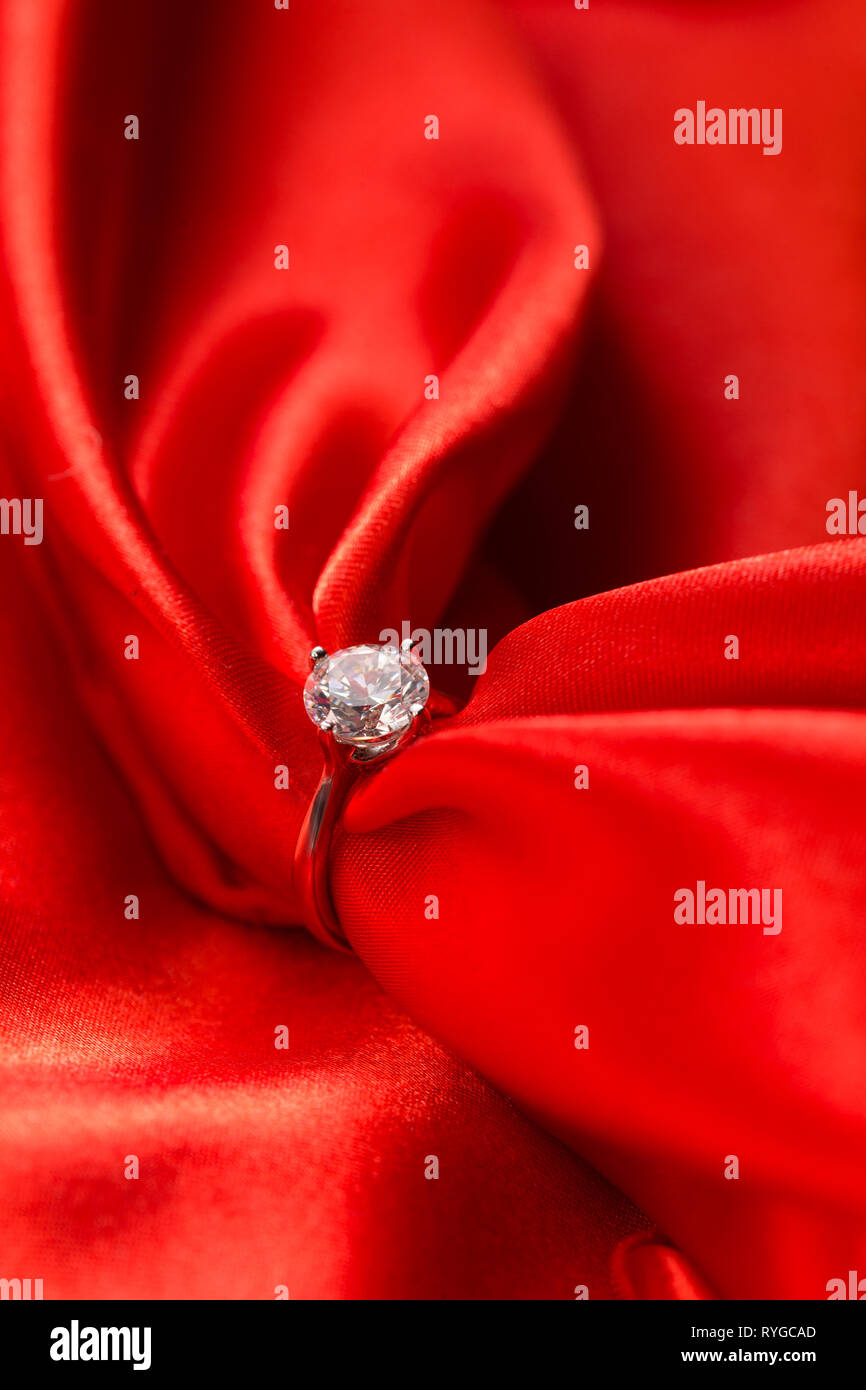Red silk and a diamond ring Stock Photo - Alamy