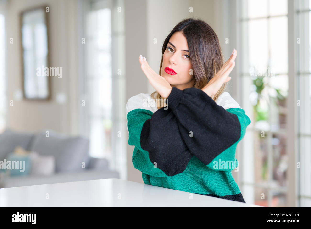 Young beautiful woman wearing winter sweater at home Rejection ...