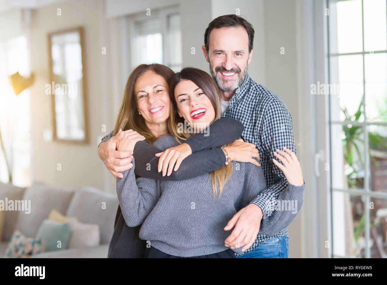 Beautiful family together. Mother, father and daughter smiling and ...