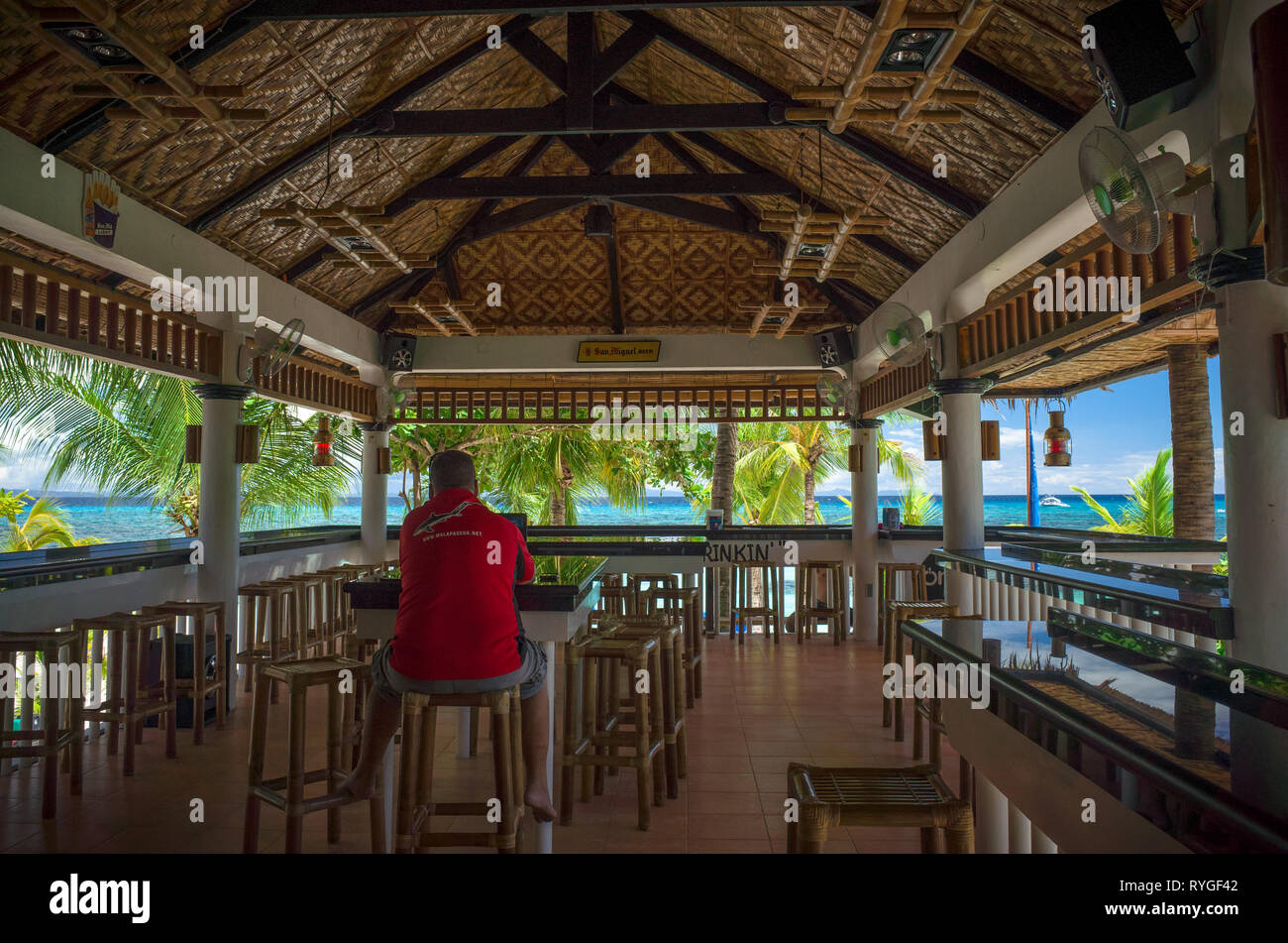 Beach bar and resto interior with seating and turquoise sea view ...