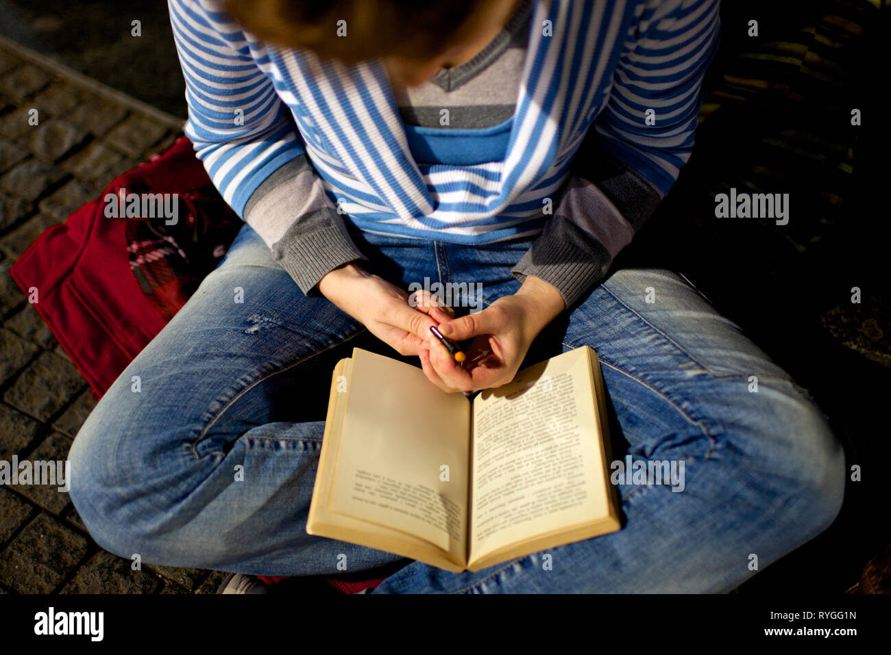 Teenager reading a book, shot from above Stock Photo - Alamy