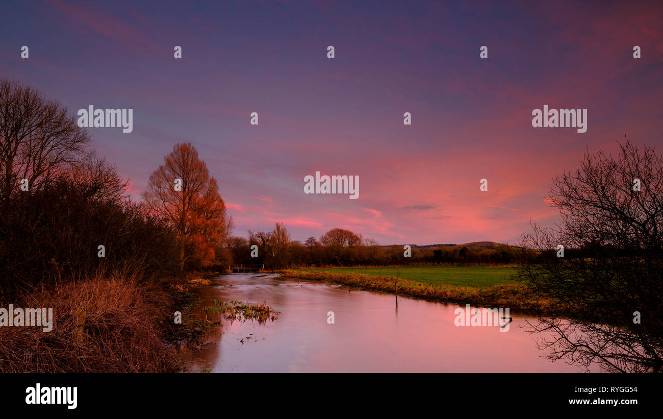 The River Meon at sunset with Old Winchester Hill, Exton, Hampshire, UK ...