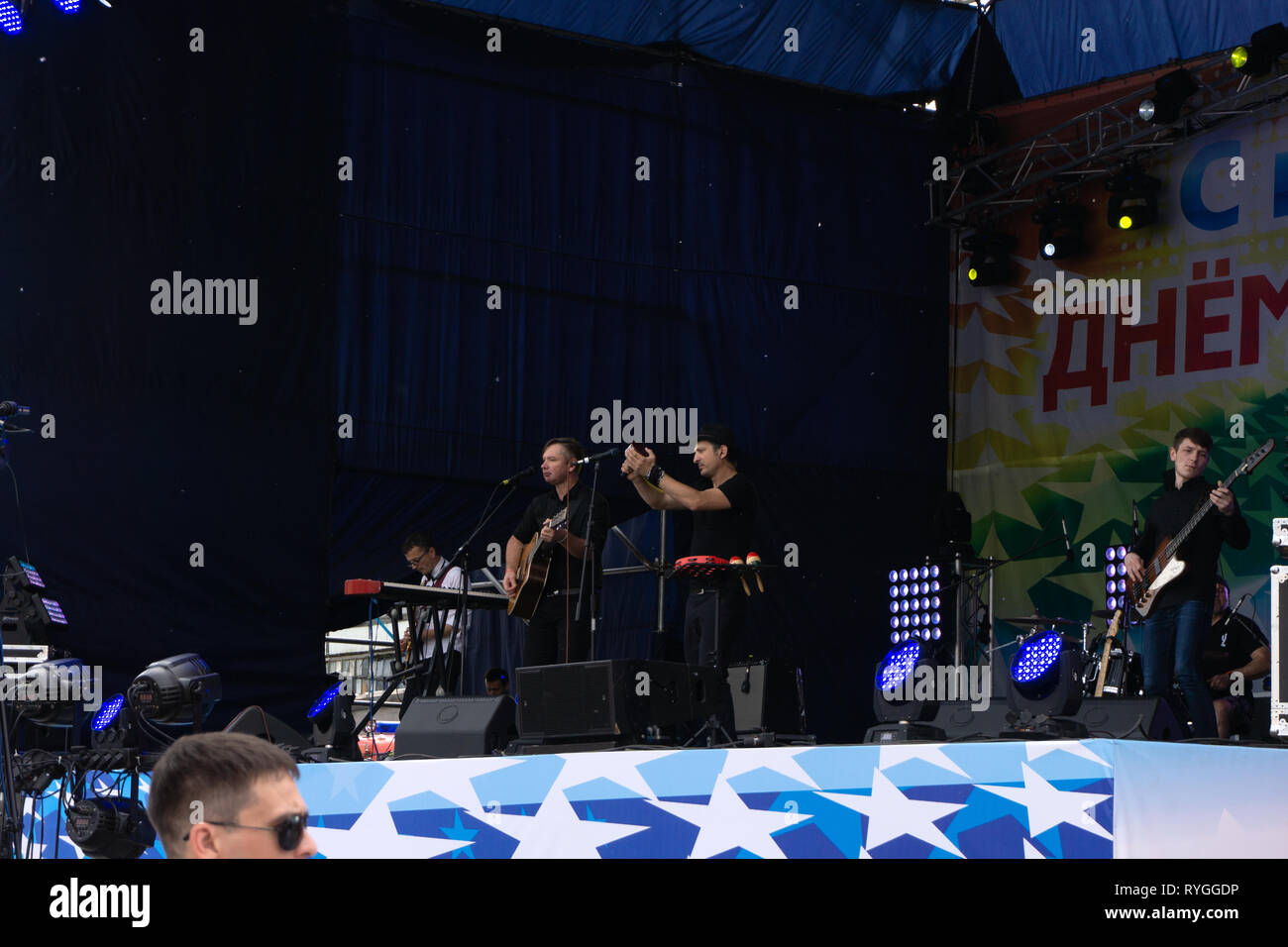 Band red silhouette crowd. Popular singer on stage in front of crowd on ...