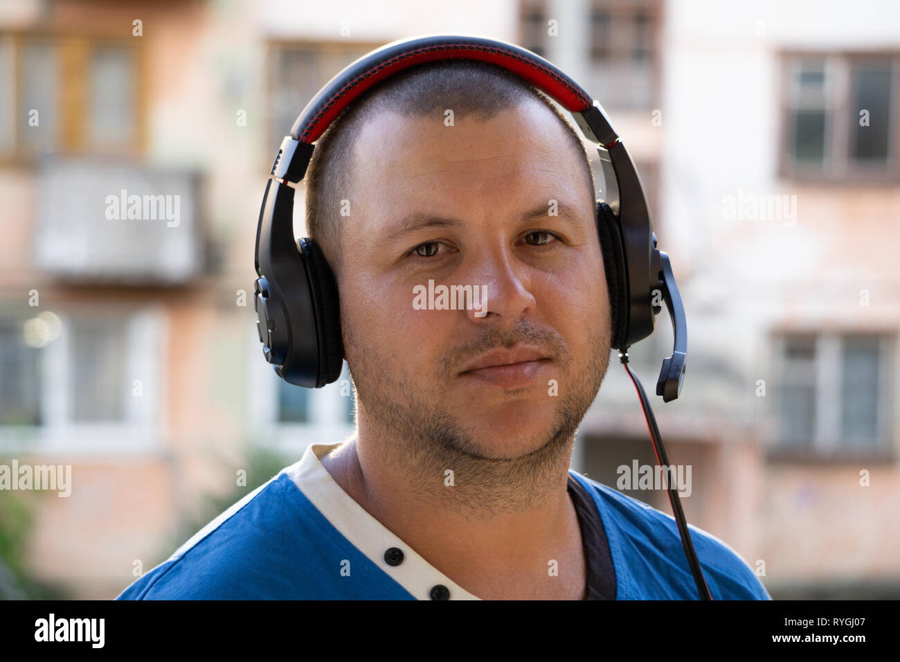 Hip-hop DJ with headphones on his head at the controls. vertical view ...